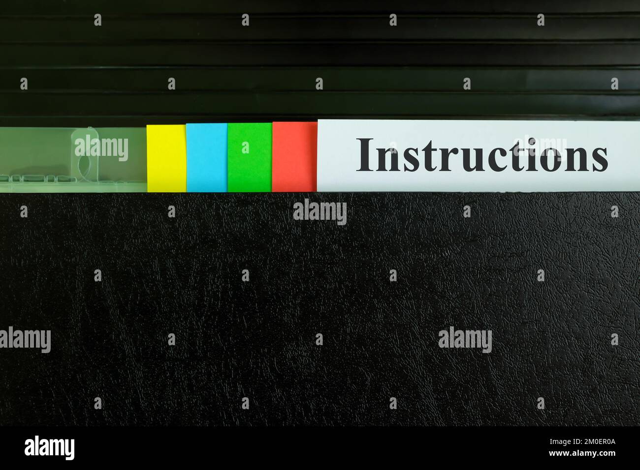 Hand picking instructions file record in black binder folder. Work ...