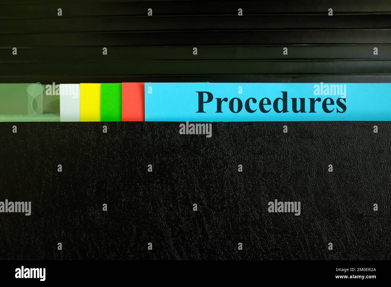 Hand picking procedures file record in black binder folder. Work ...