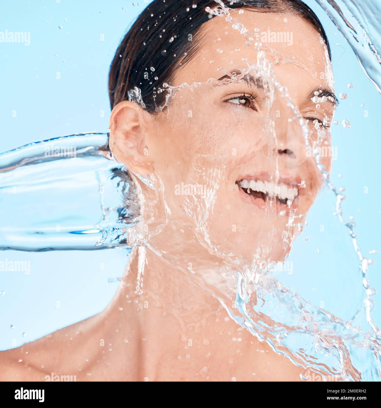 Water splash, happy or woman in shower cleaning her face or body in ...