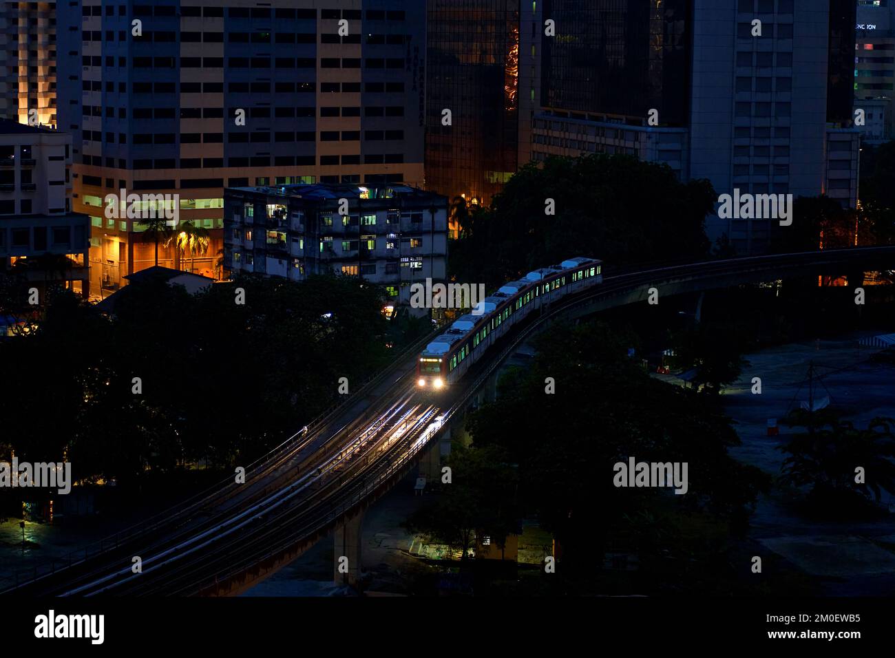 Light rail transit train moving through the city in the night Stock ...