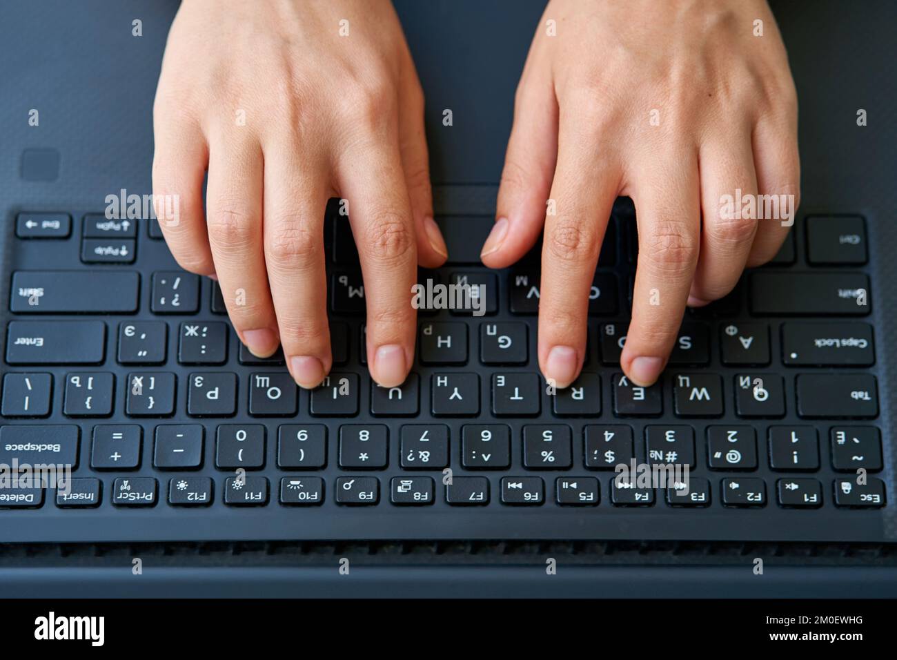 Person is typing on a laptop. Vida from above hands typing text on the ...