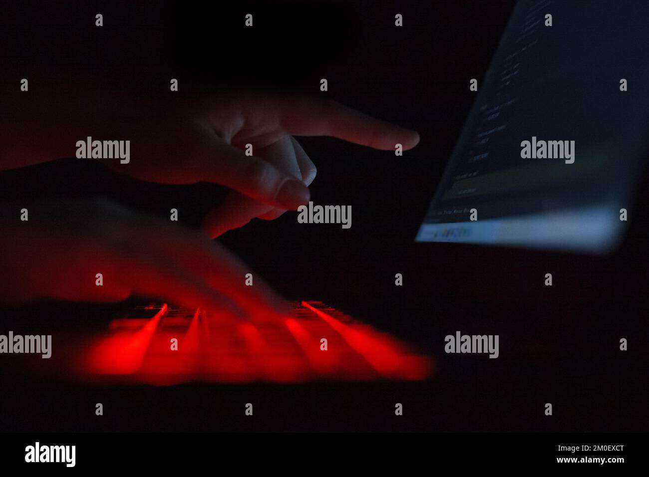 Person pointing on laptop screen with red backlight Stock Photo - Alamy