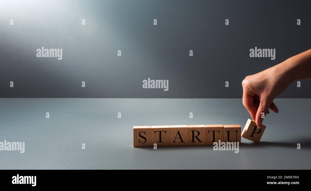 hand posing wooden blocks , concept of startup or beginning a new ...
