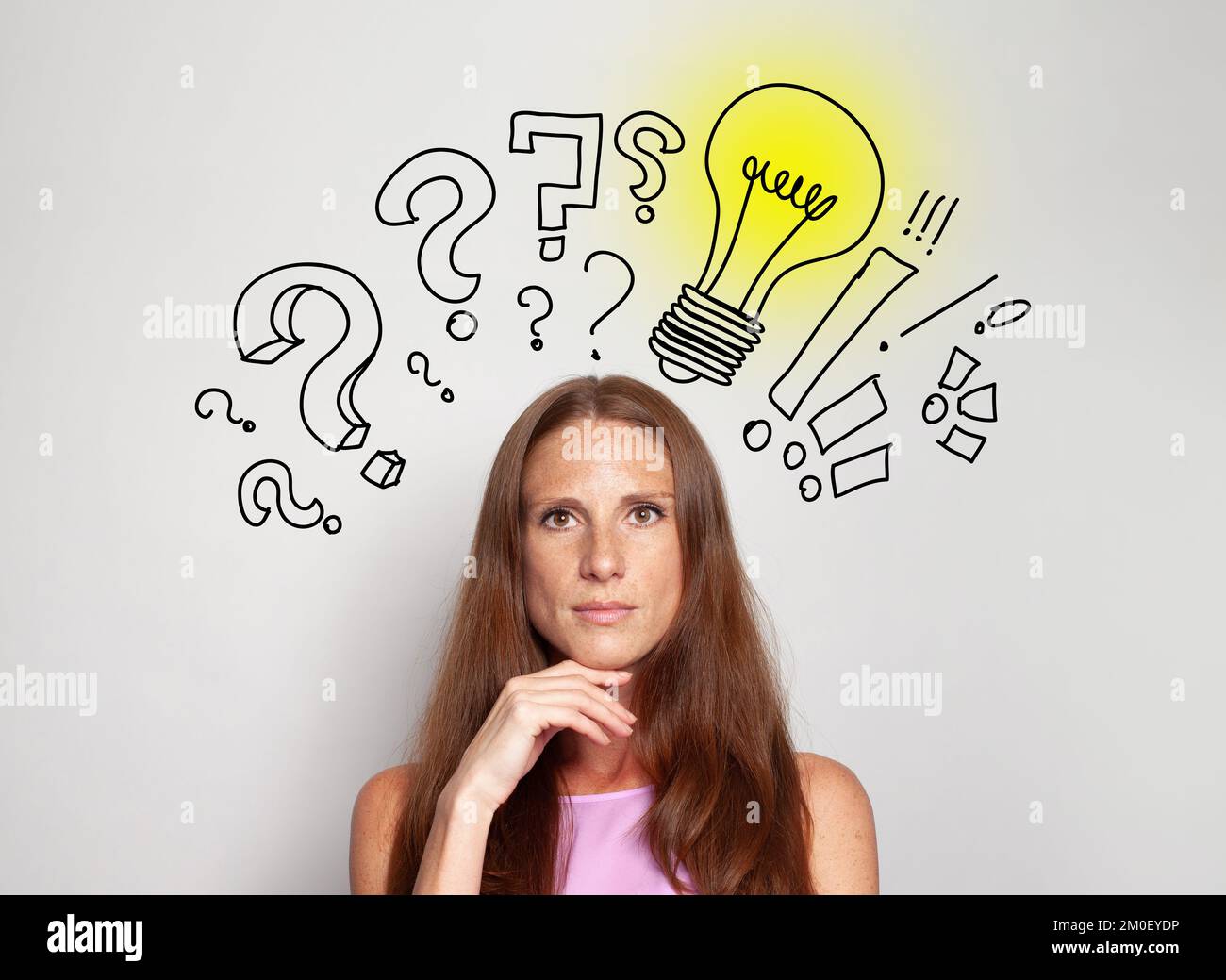 Pensive serious mature brunette woman with question marks and bulbs ...