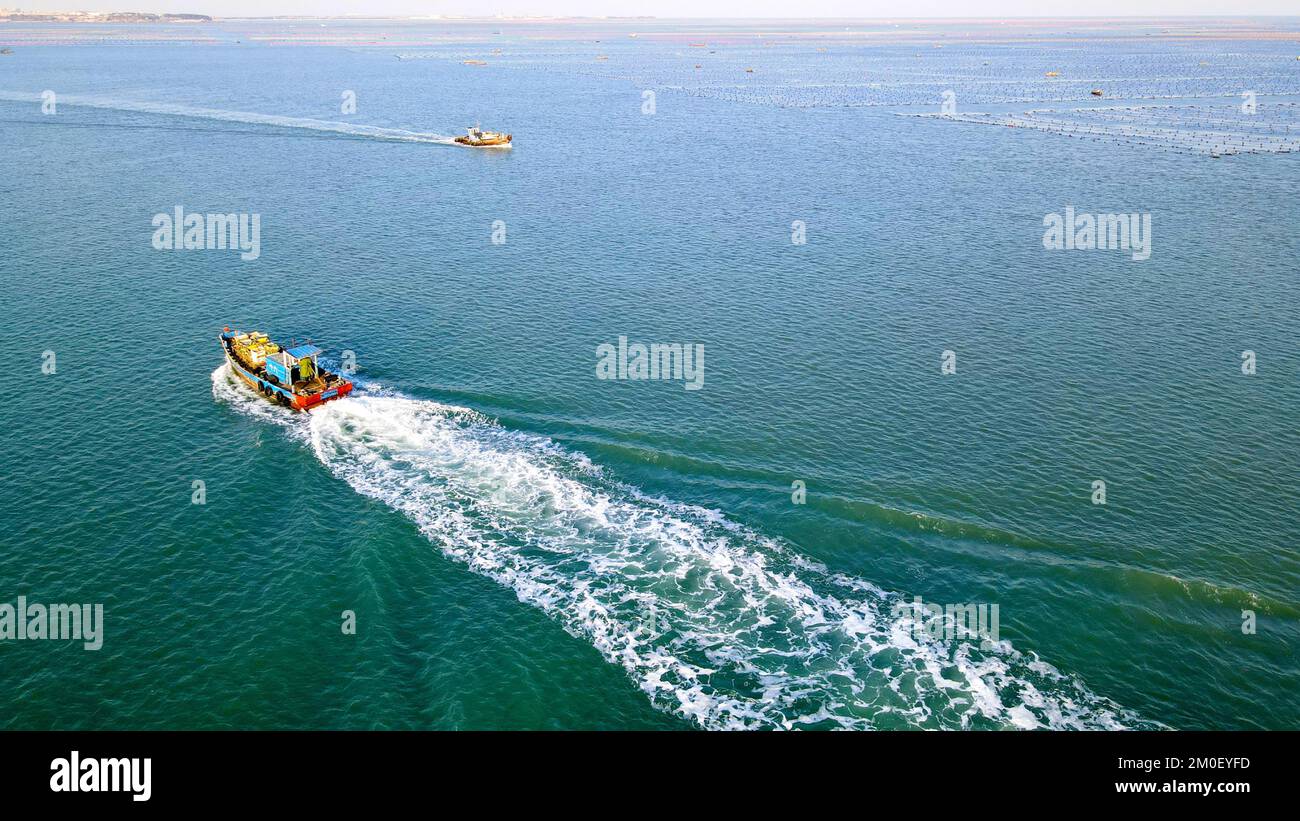 Aerial photos show fishermen engaged in marine production at the marine ...