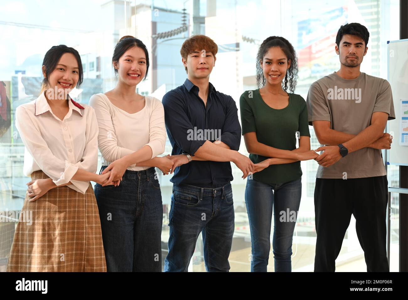 Successful start up business people standing in line and holding hands ...