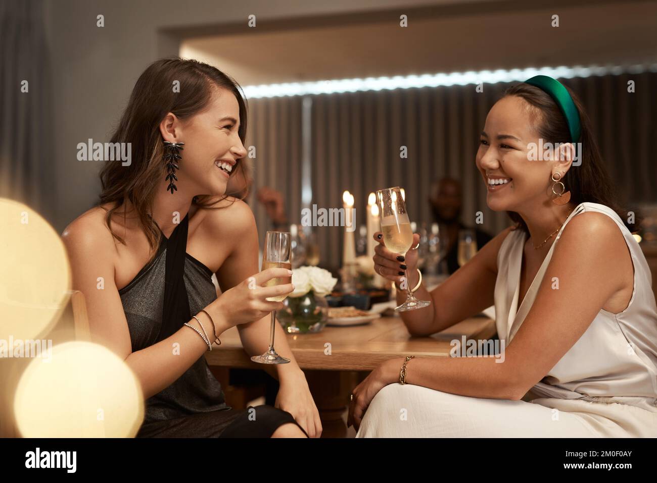 Friends, champagne and women in restaurant, party and dinner for ...