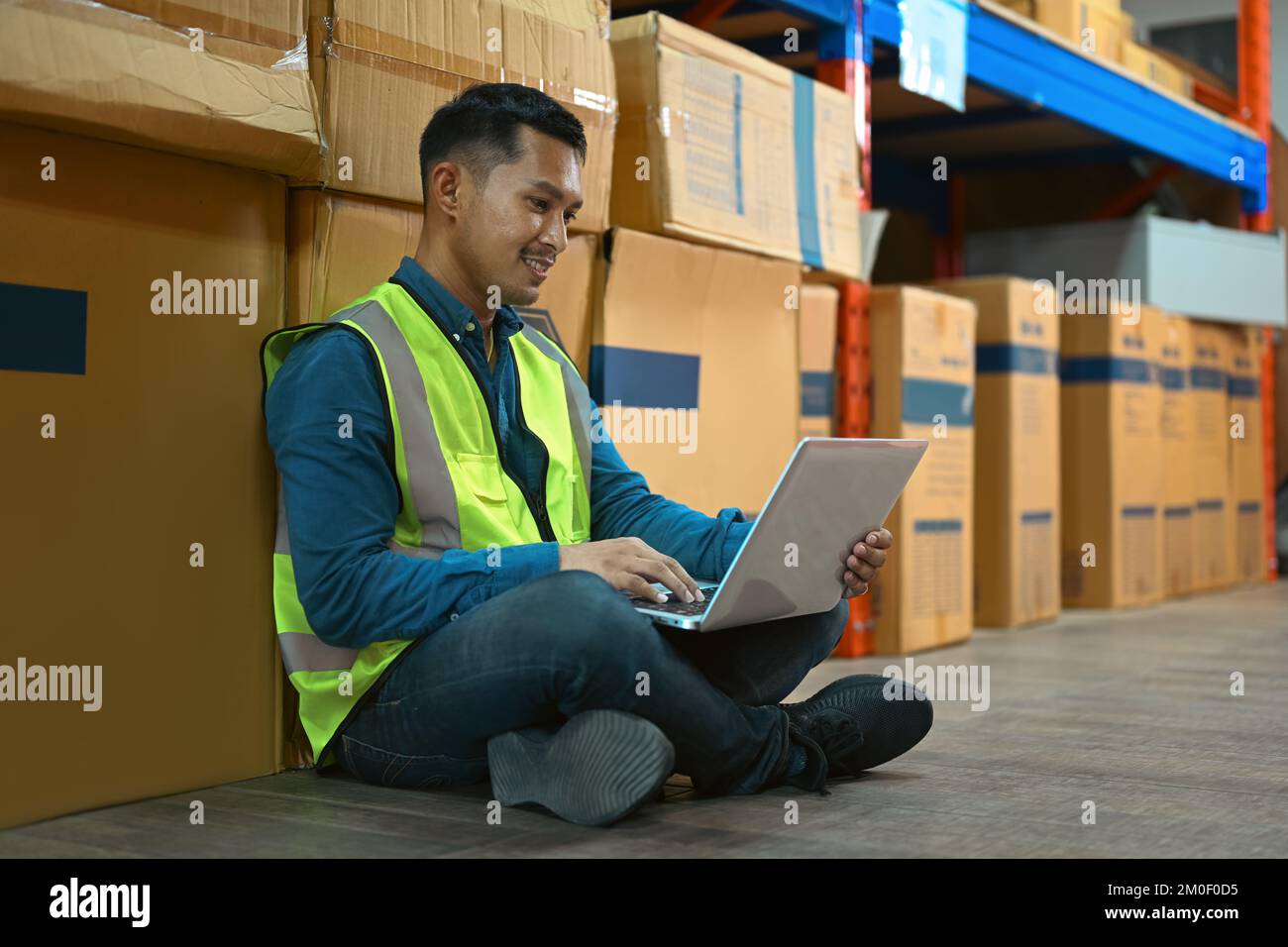 Man industrial worker checking stock and inventory on laptop while ...