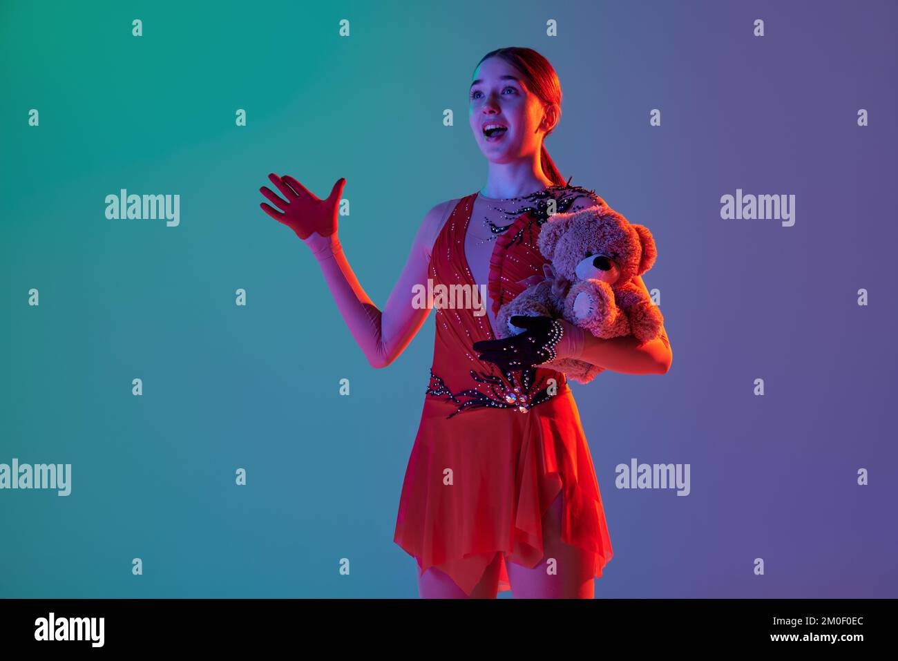Surprised young girl, female figure skater in stage costume expressing ...
