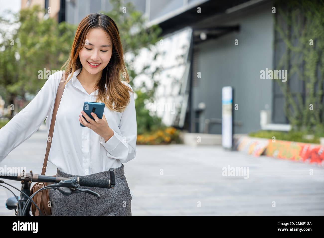 Portrait of beautiful smile business woman commute her bicycle outdoor ...