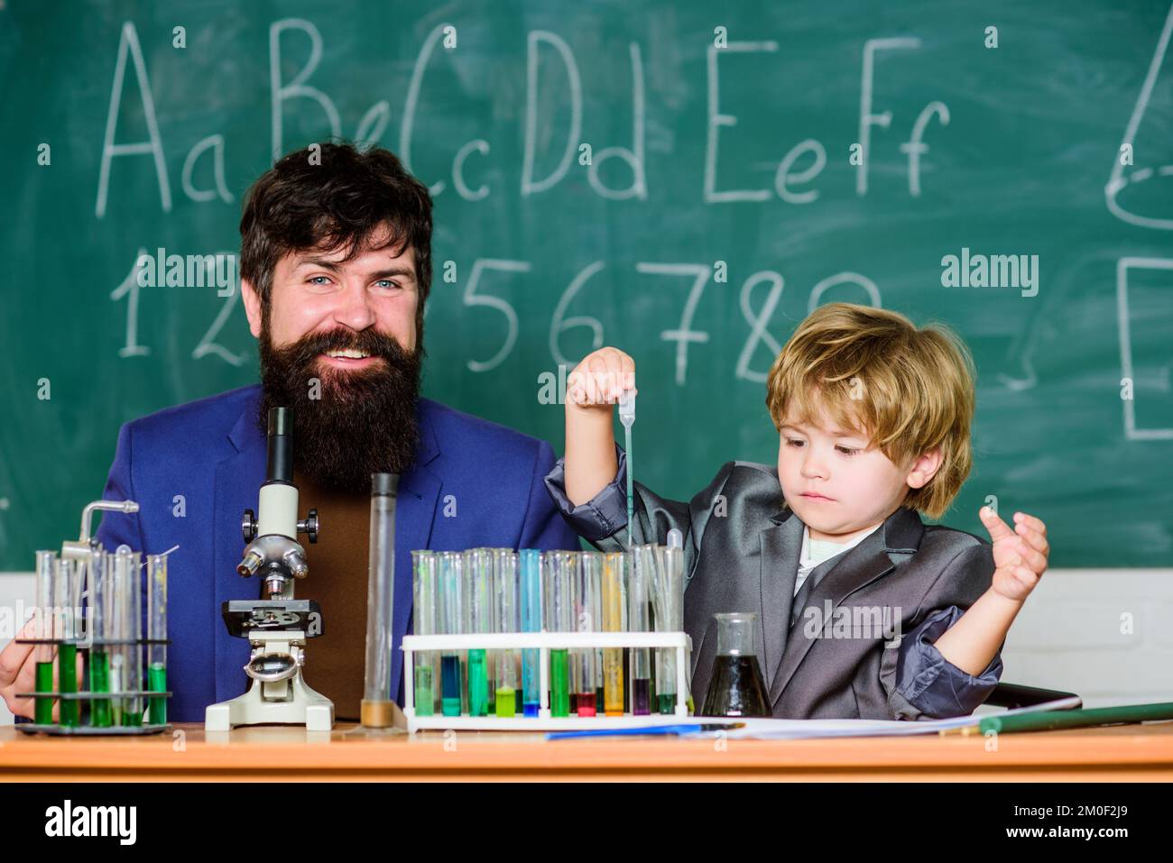 I love study in school. School laboratory. Teacher and pupil boy in ...