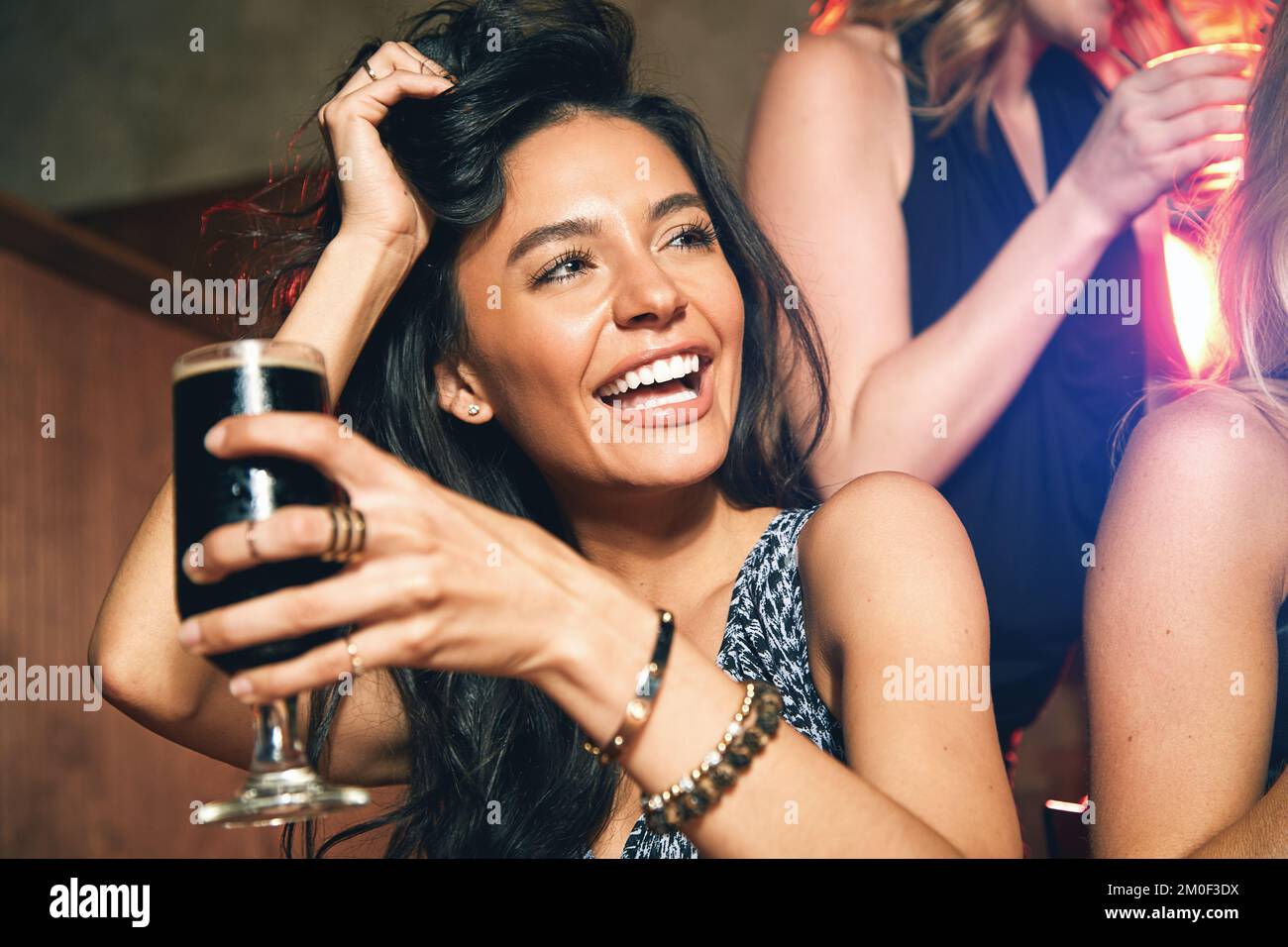 Young woman with beer, alcohol and party at nightclub with new year celebration and happiness ...
