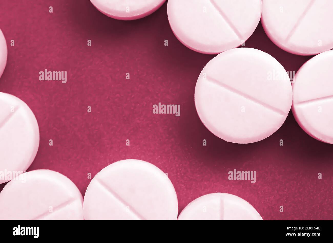 A few white tablets lie on a bright background surface. Background ...