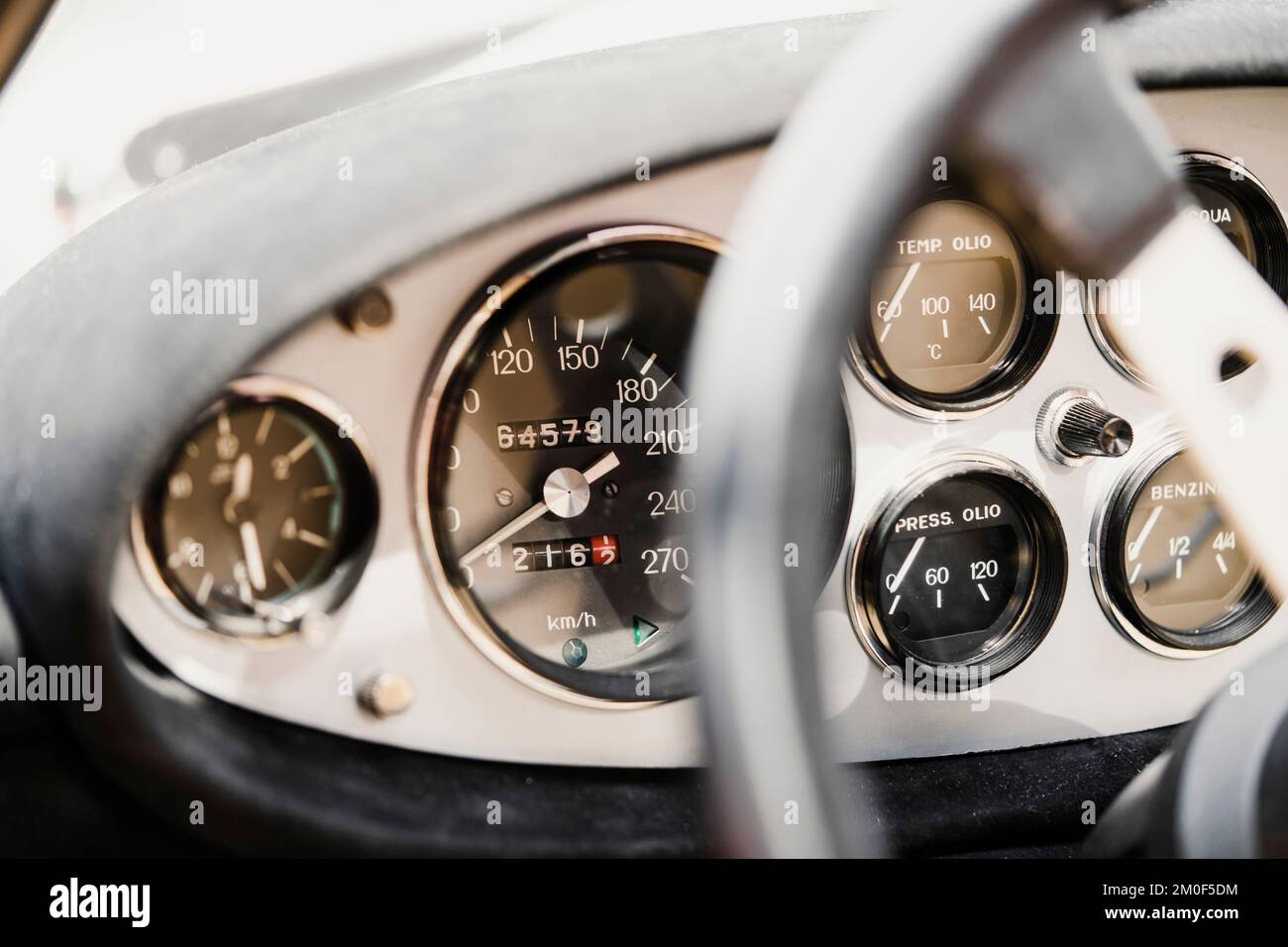 Close up hot of a vintage dashboard with various gauges on a retro car ...