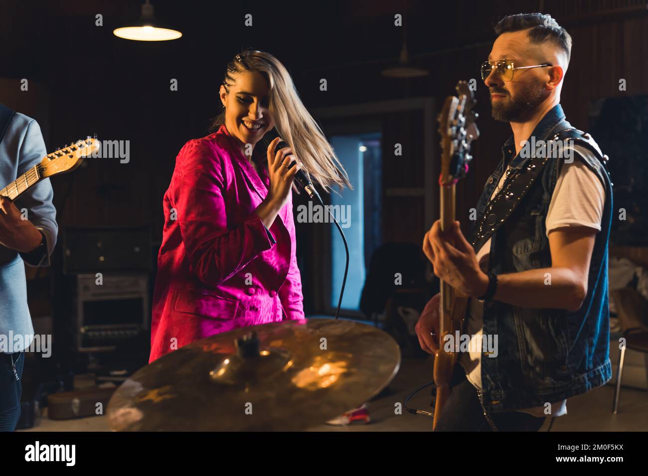 Music band with a female singer recording a song in a studio. High ...