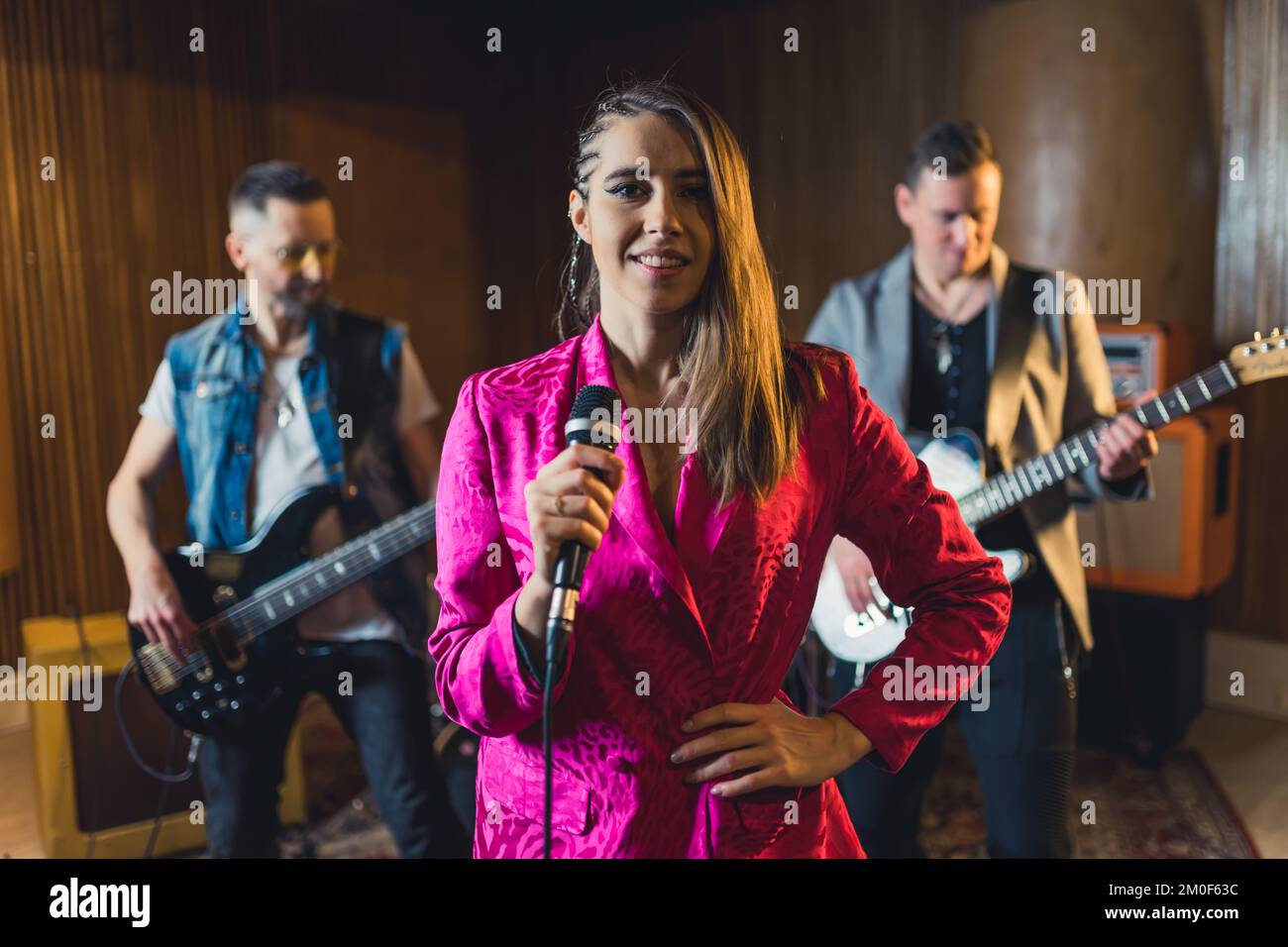 A woman singer with two man accompanying her on the guitars. High ...