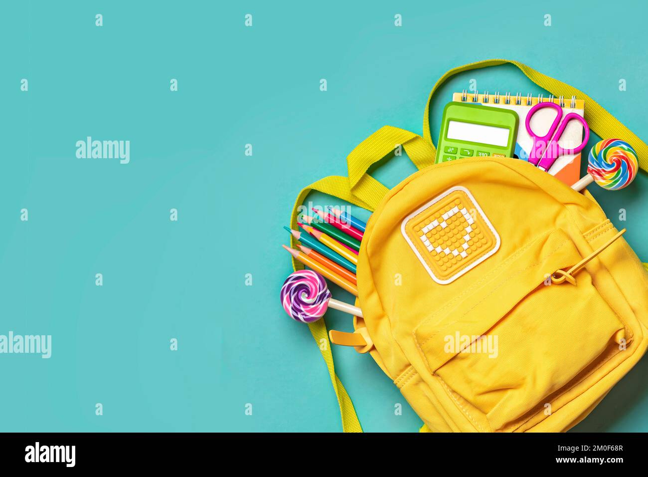 Back to school, education concept Yellow backpack with school supplies ...