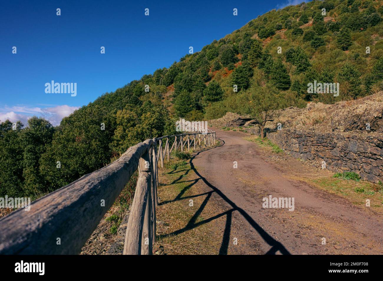 fence and winding path in autumnal landscape of Sicily, Etna Park ...