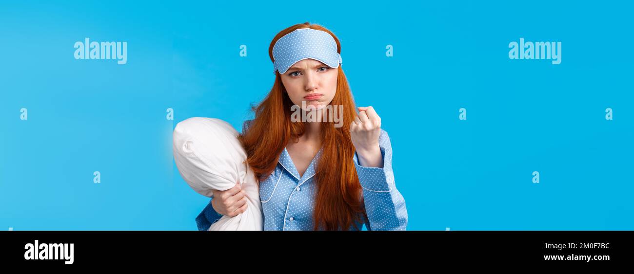 Who disturbed my sleep. Mad and displeased, angry grumpy redhead woman ...