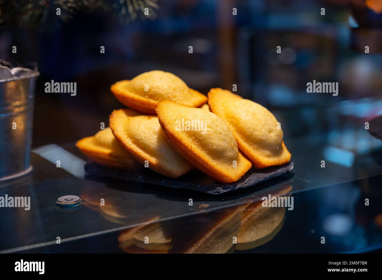 French sweet dessert pastry madeleine on display in french bakery close ...