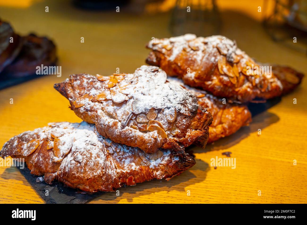 French sweet dessert pastry with almonds on display in french bakery ...