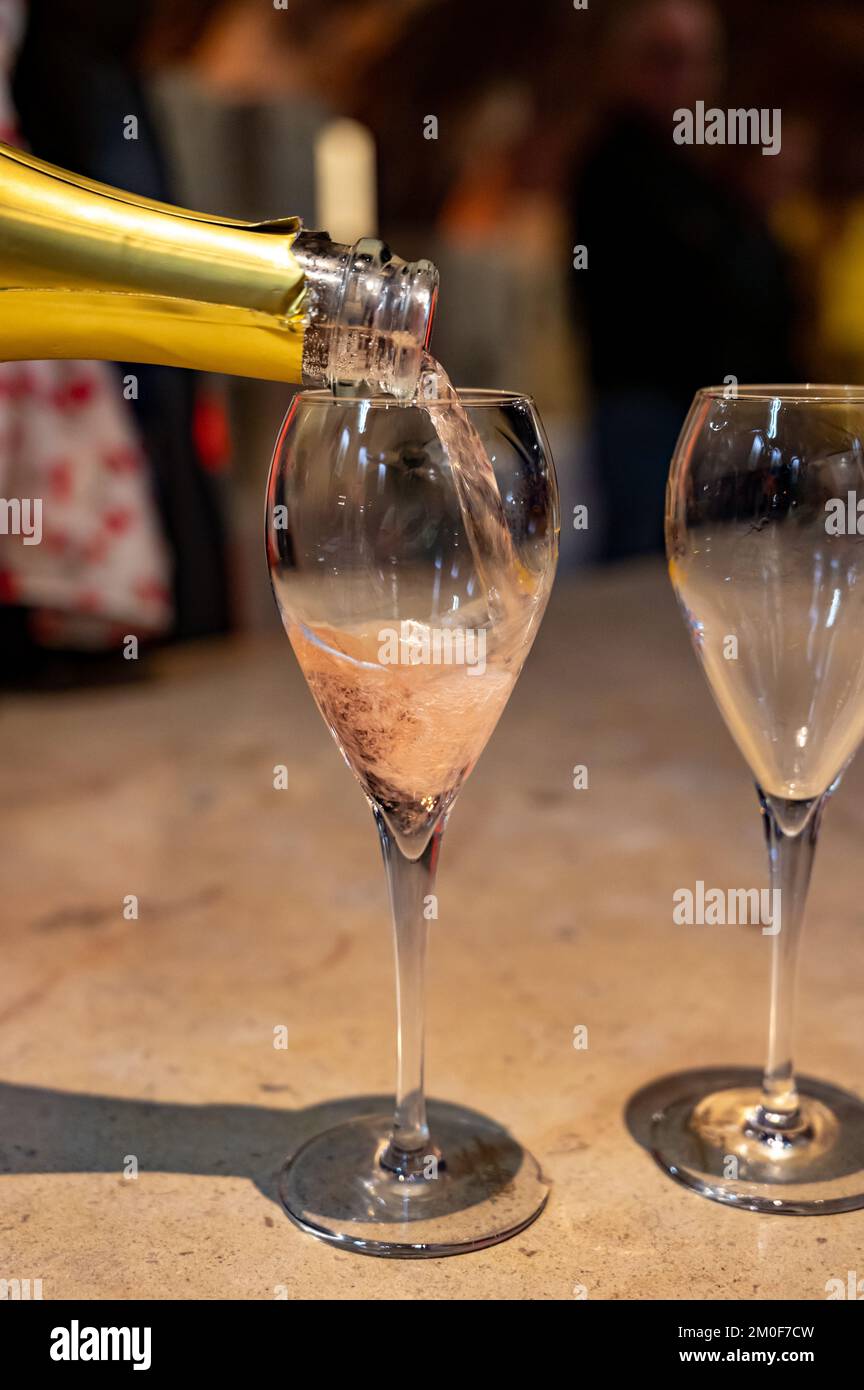 Tasting of rose champagne sparkling wine produced by traditional method in dark underground ...