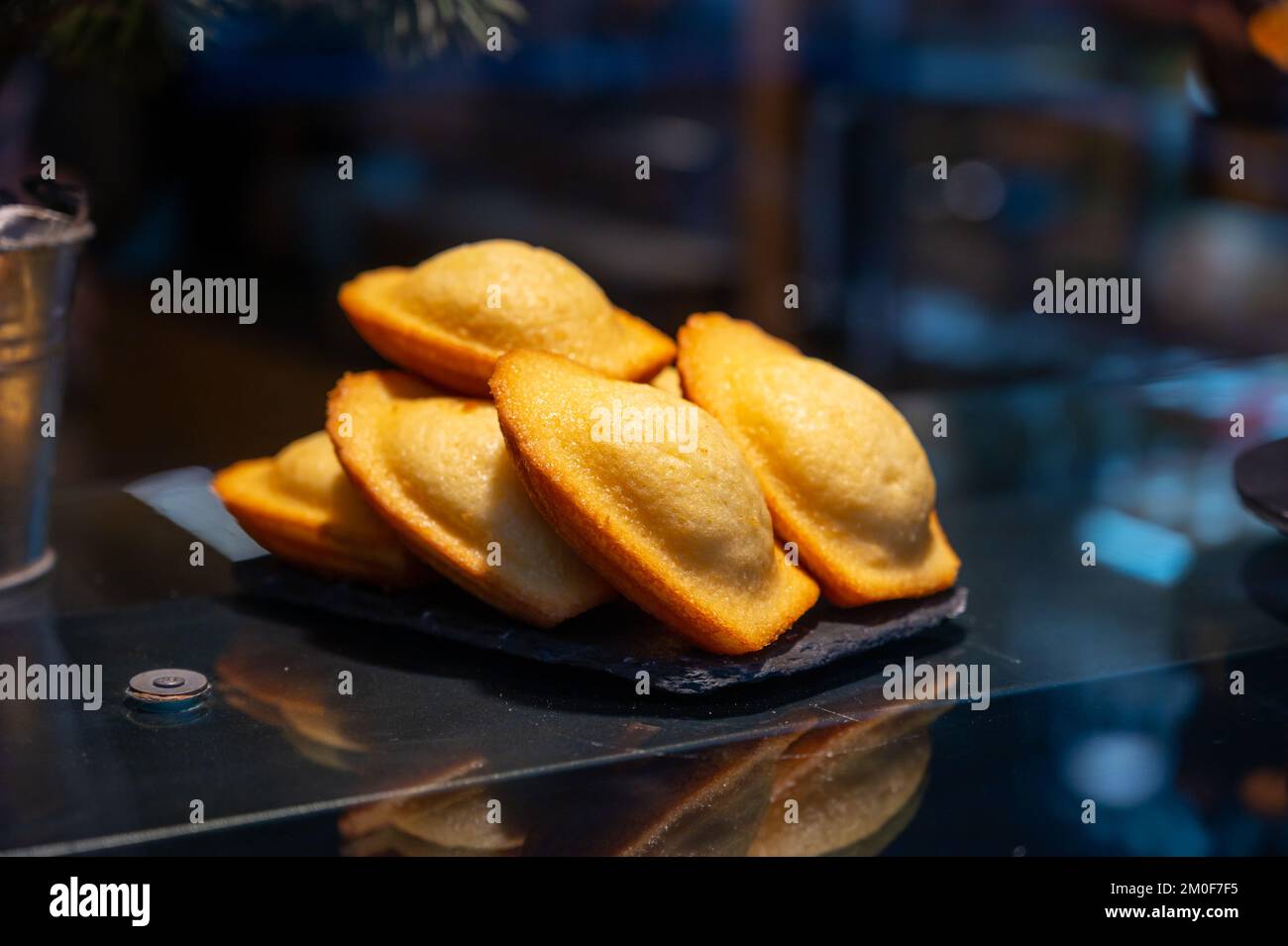 French sweet dessert pastry madeleine on display in french bakery close ...