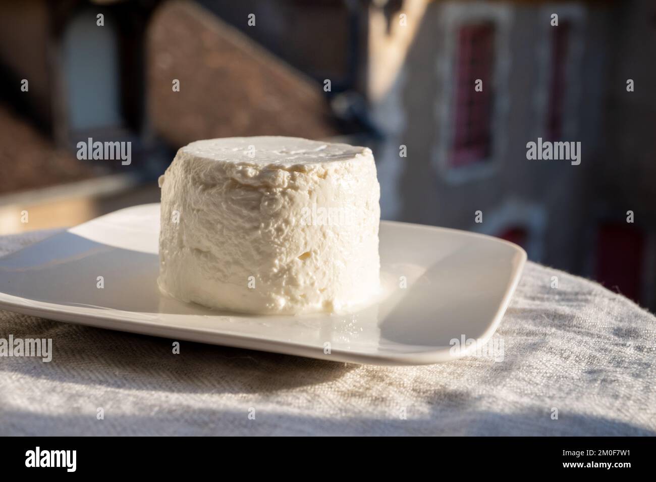 French soft white goat cheese served outdoor in old city in sunlights ...