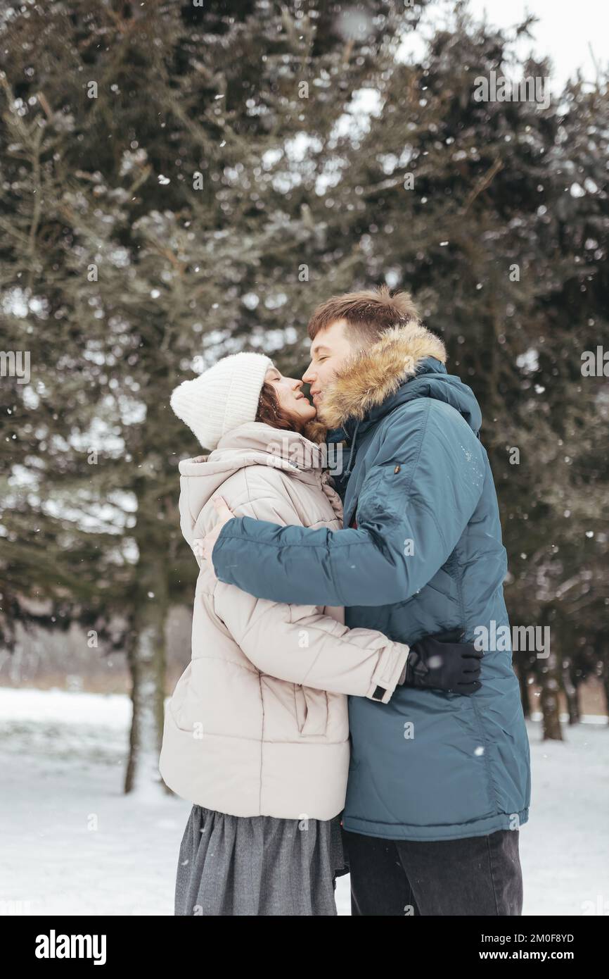 A couple is kissing in the snowy forest Stock Photo - Alamy