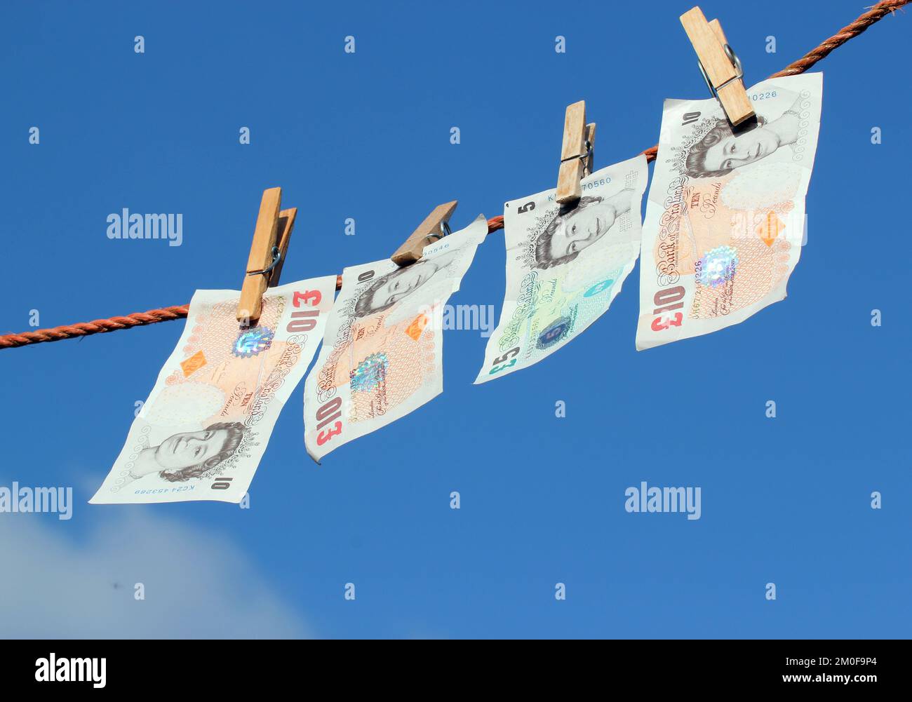 Banknotes hanging out on a washing line to dry. Concept money ...
