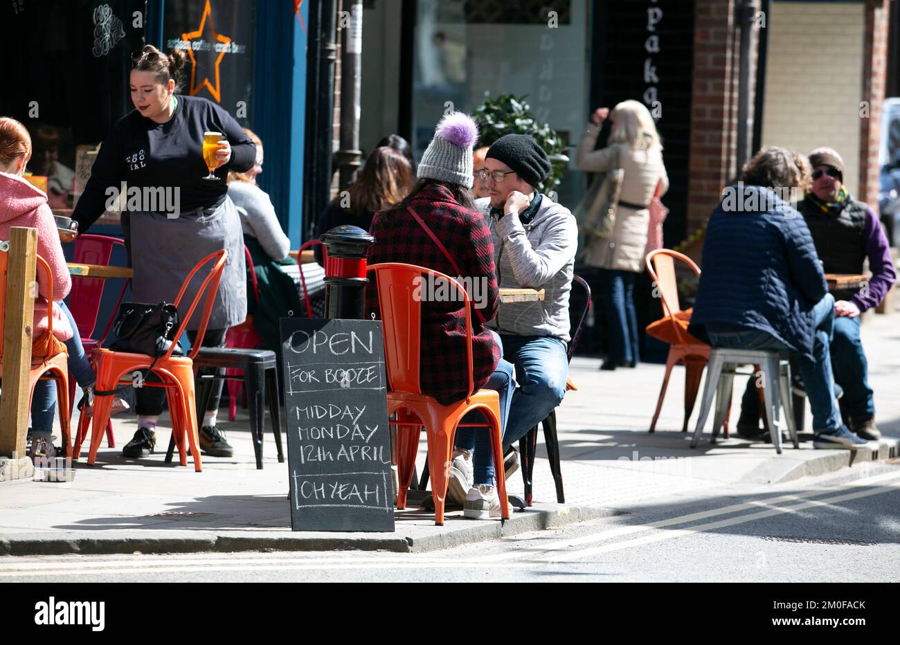 People out drinking on April 12th 2021 at bar tables on the pavement in ...