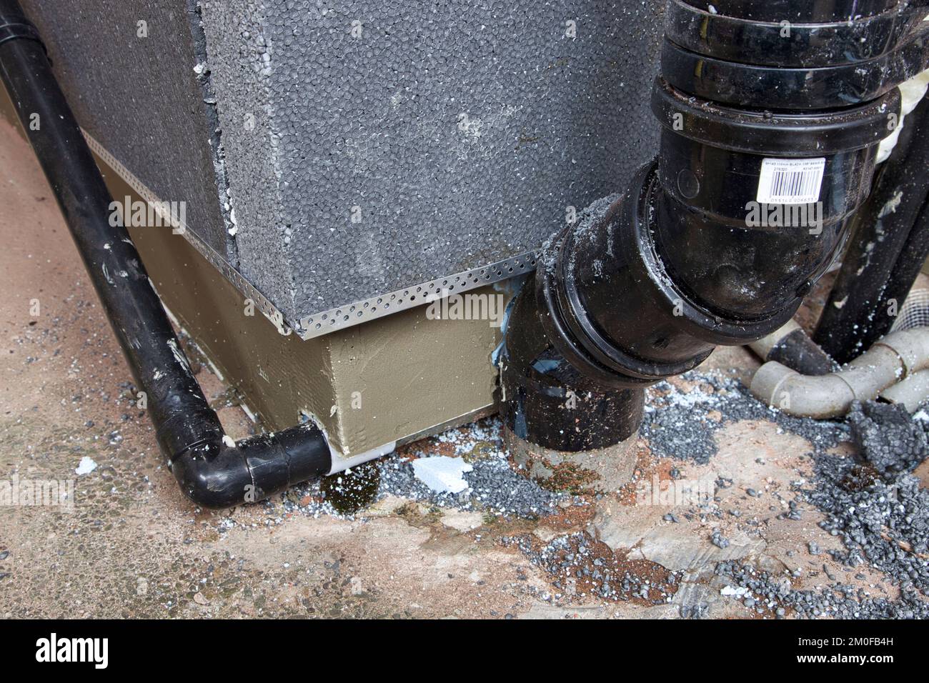 External wall insulation pipe going into base track Stock Photo - Alamy