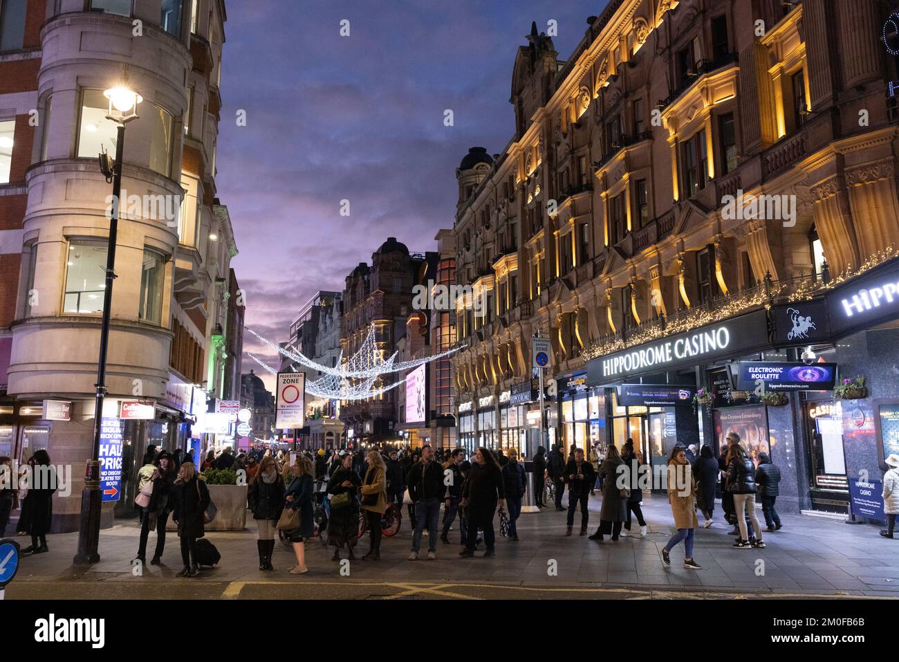 Leicester Square illuminated with Christmas lights at twilight, in the ...