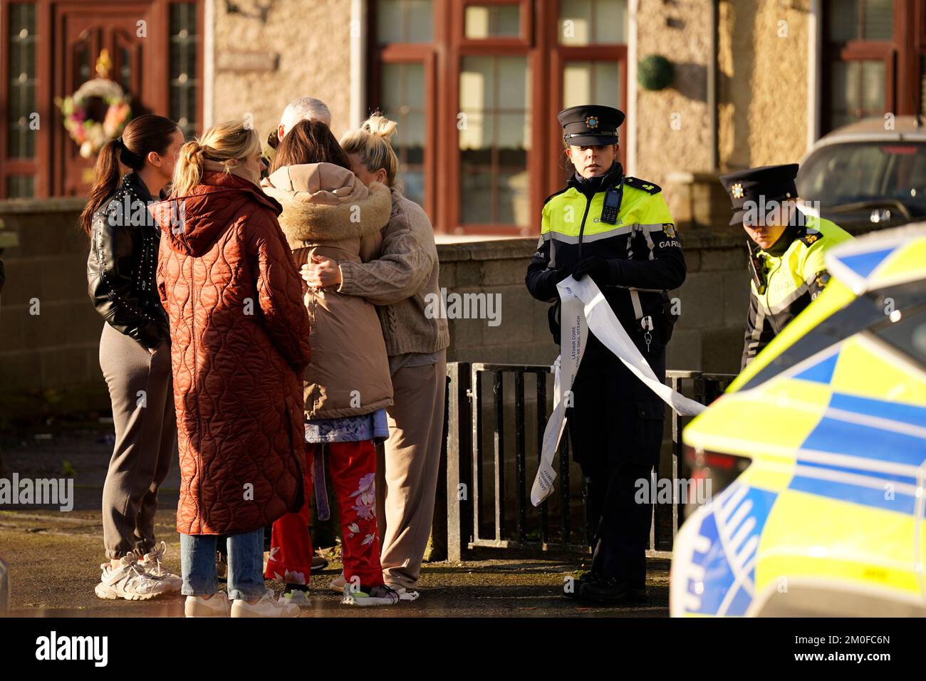 Family members are consoled at the scene in Ronanstown, Dublin, where a ...