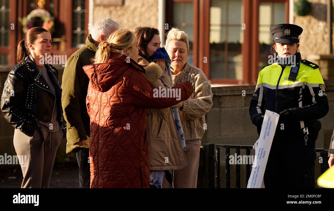 Family members are consoled at the scene in Ronanstown, Dublin, where a ...