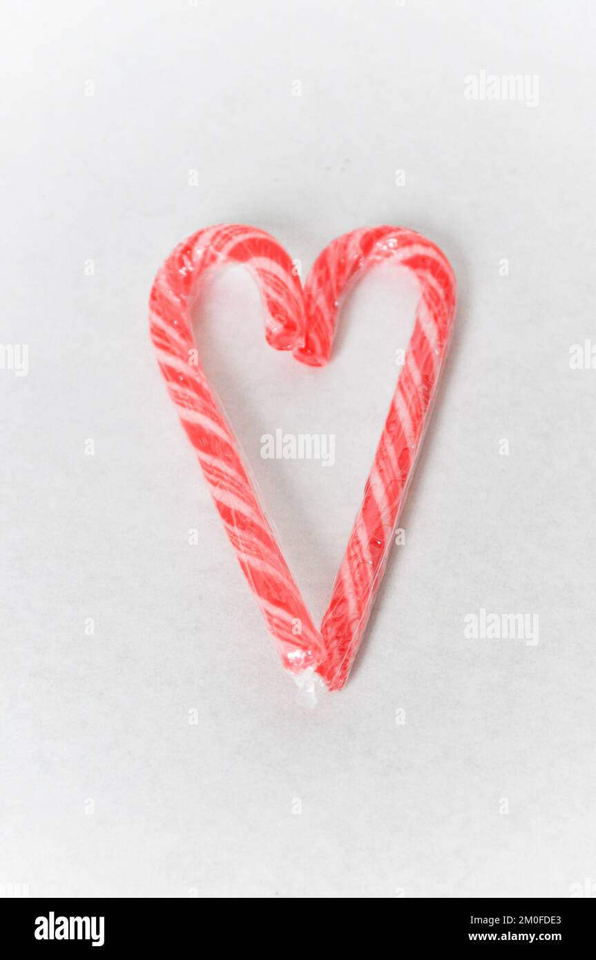 Traditional Christmas candy canes set to represent a love heart shape ...