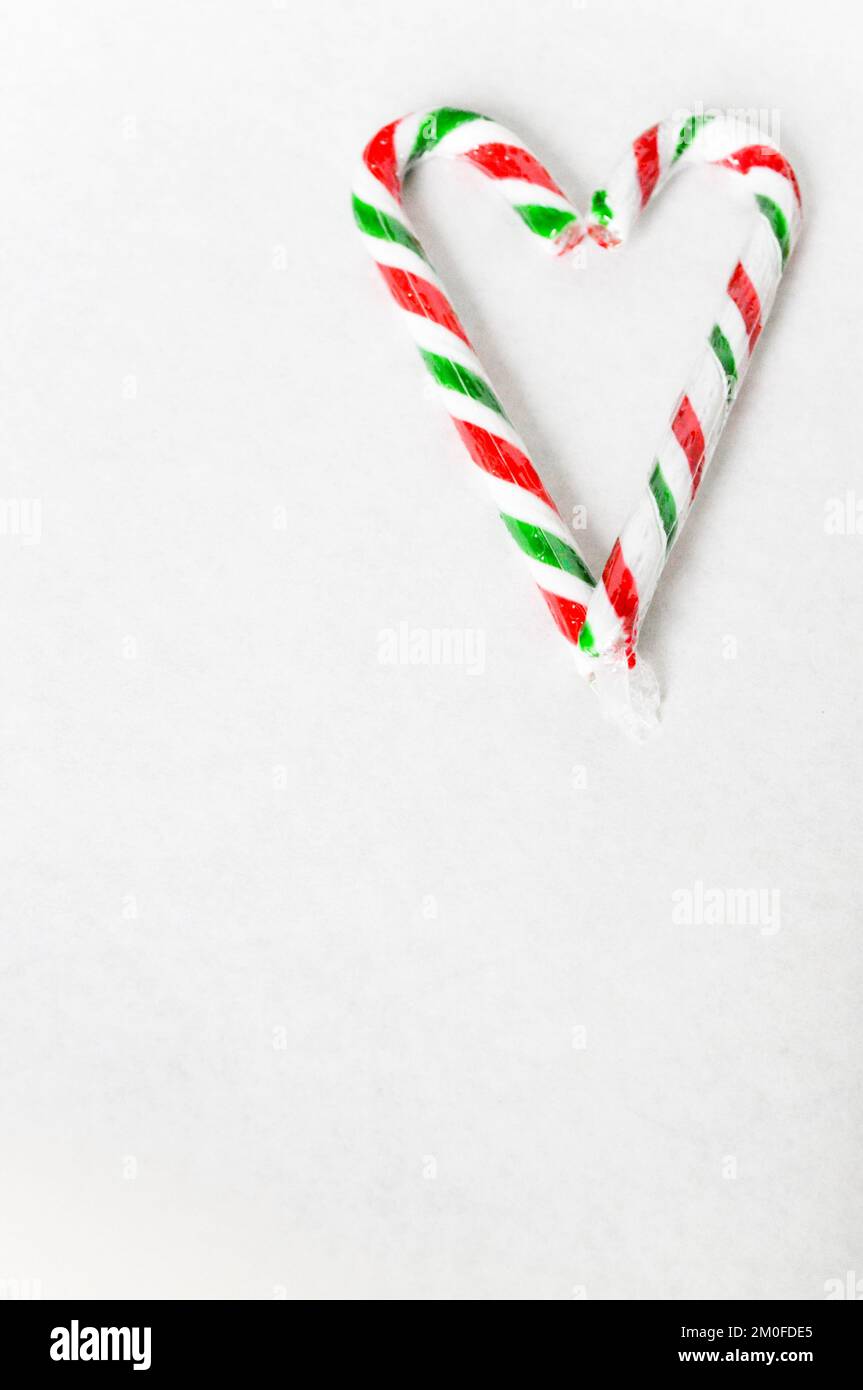 Traditional Christmas candy canes set to represent a love heart shape ...