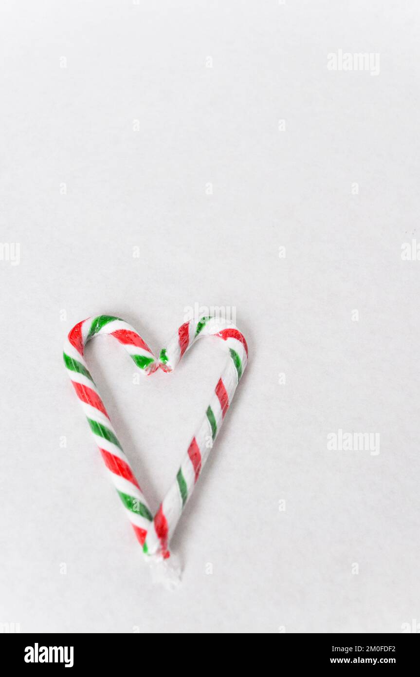Traditional Christmas candy canes set to represent a love heart shape ...