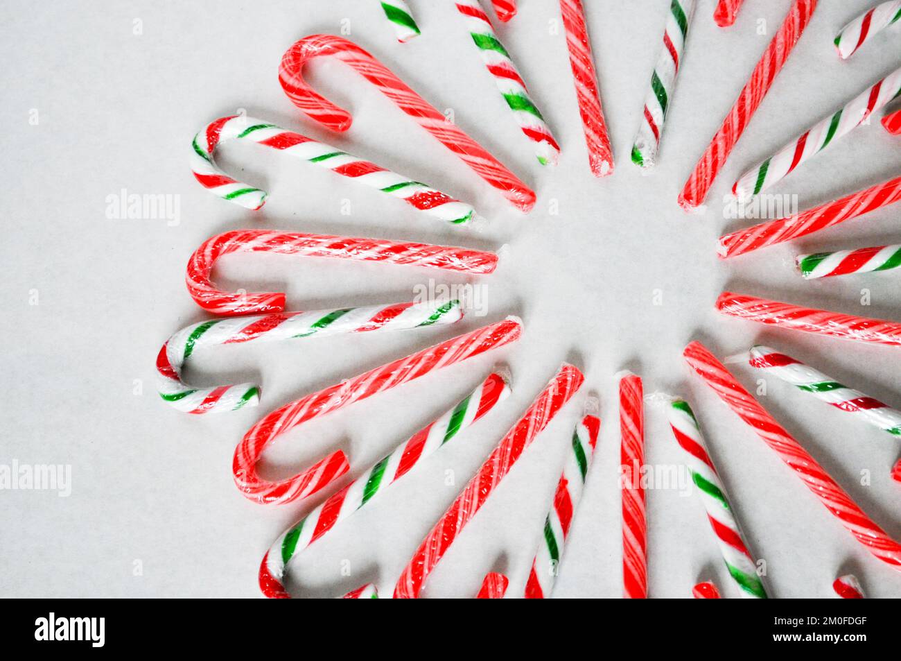 Traditional Christmas candy canes set against a white background in the ...