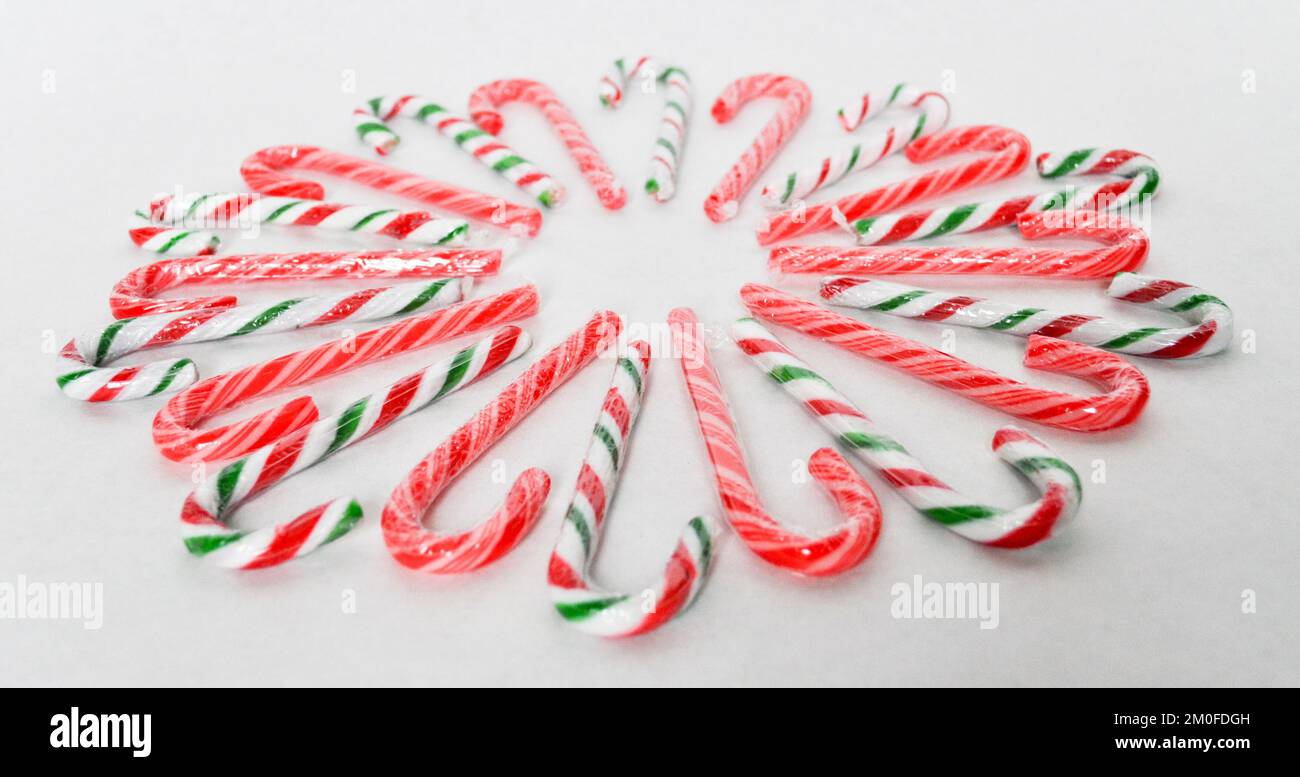 Traditional Christmas candy canes set against a white background in the ...