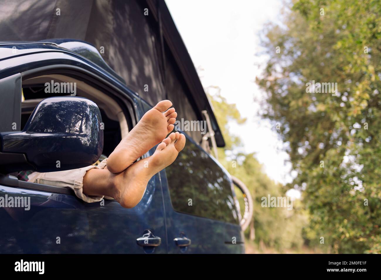 feet of a man leaning in the window of his camper Stock Photo - Alamy