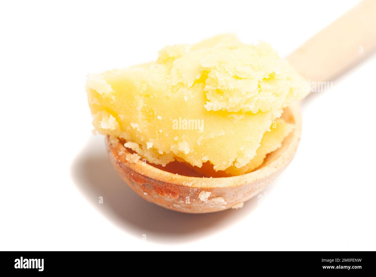 Ghee in wooden spoon isolated on white background Stock Photo - Alamy