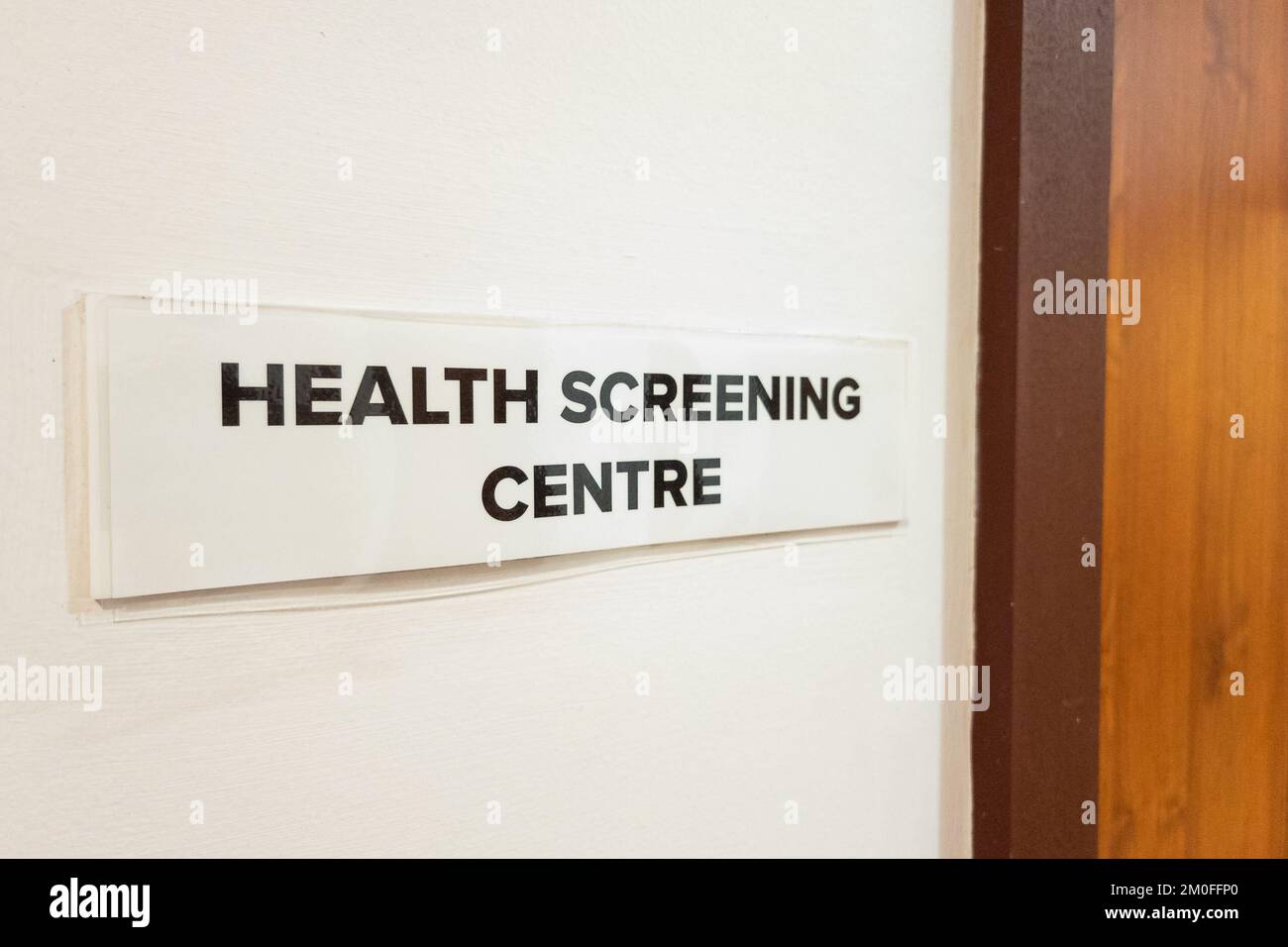 Concept of the word Health Screening Centre at the door entrance of ...