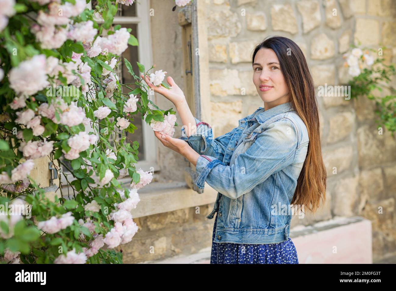 Lifestyle portrait of young stylish woman staying on the street in old ...