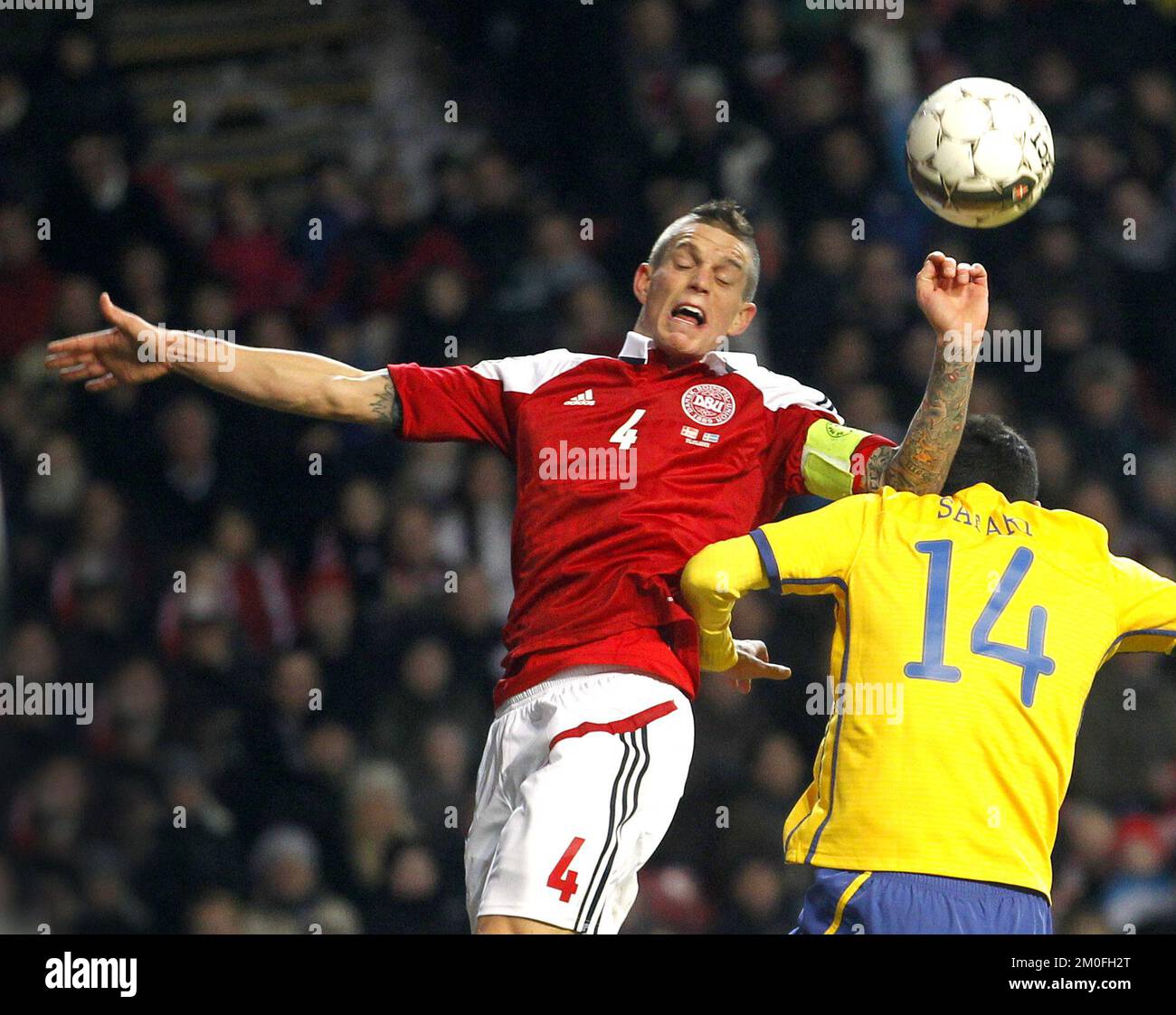 Denmark's Daniel Agger (left) and Sweden's Berang Safari (right) battle ...