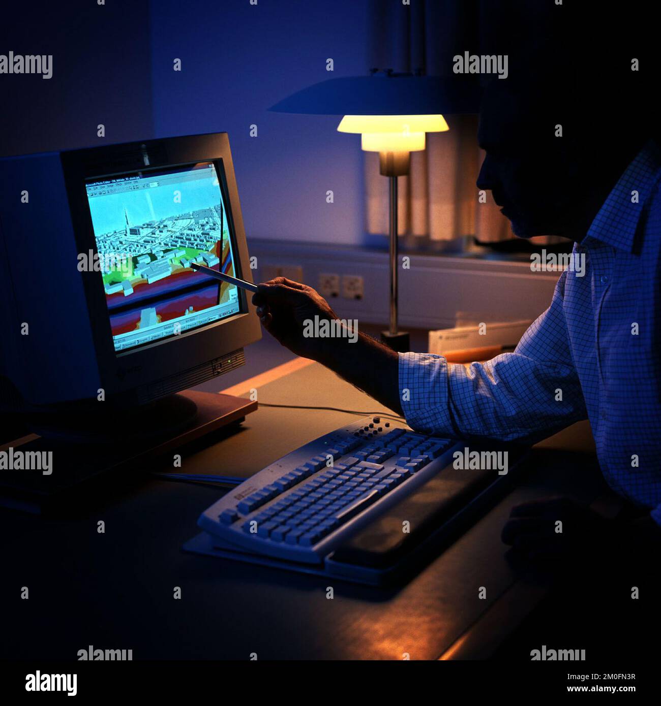 Sitting in the dark with his pc turned on hi-res stock photography and ...