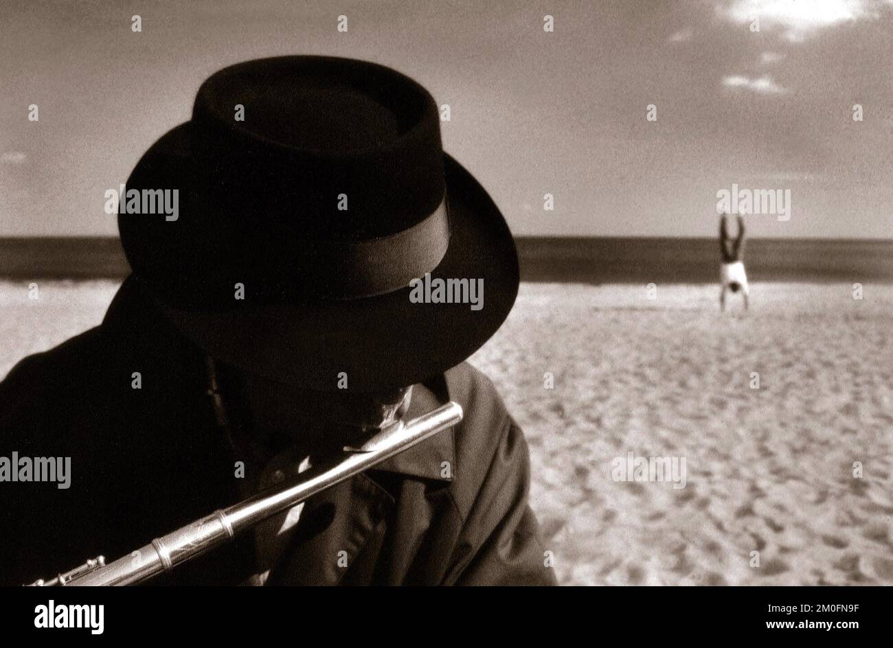 An old man playing the flute on the beach hi-res stock photography and ...