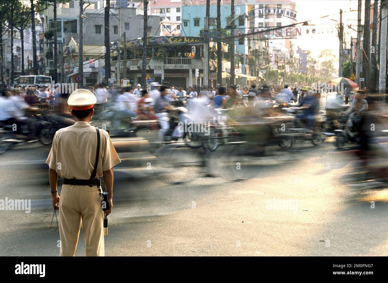 One single police officer is watching the traffic on the 3 Thang 2 road ...
