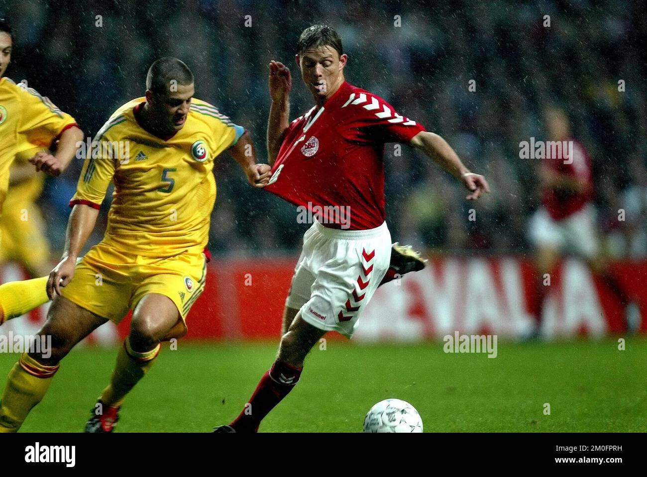 The Danish player Jon Dahl Tomasson (right) in action against Romania ...
