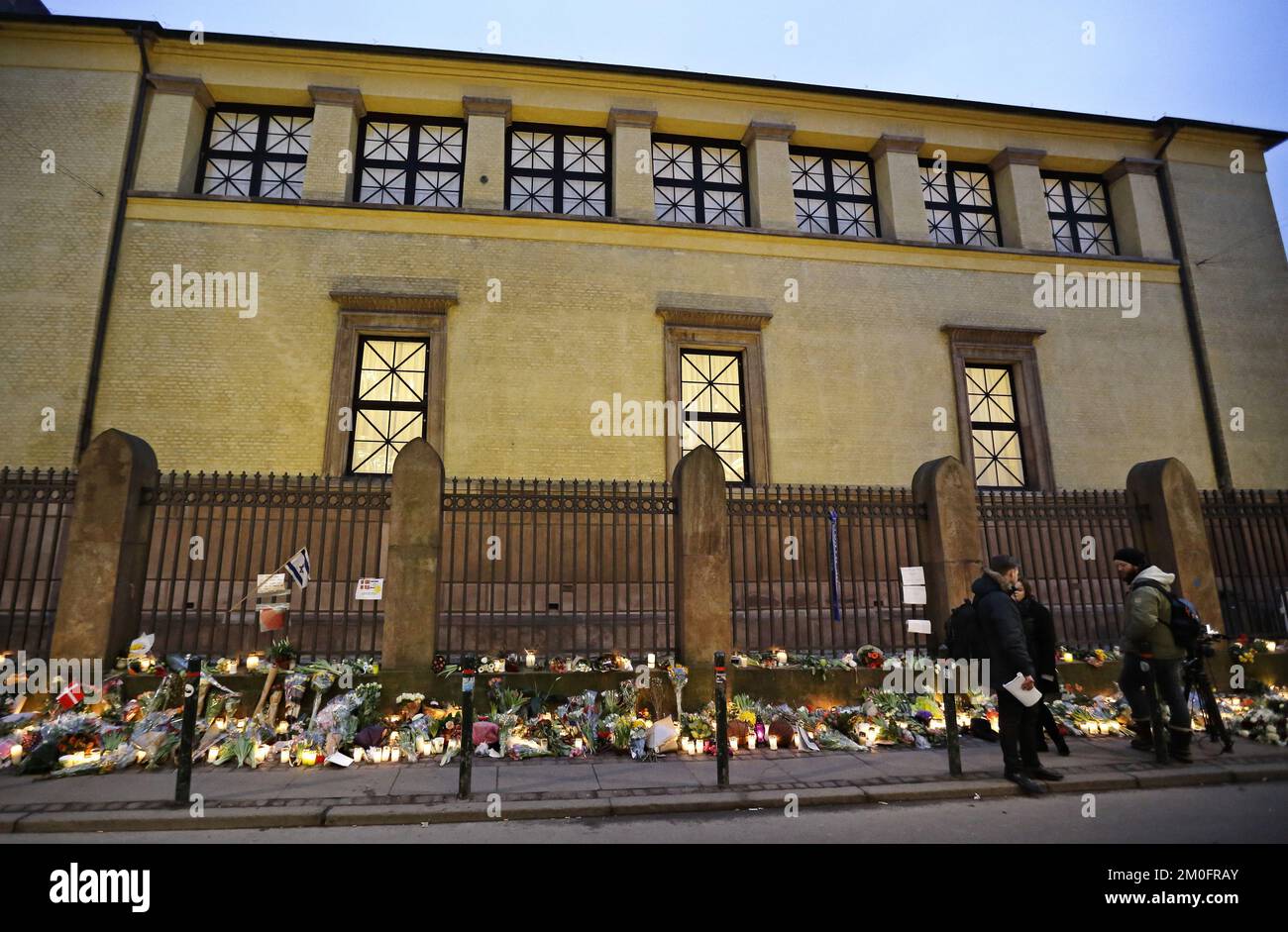 Flowers are laid outside the synagogue in Copenhagen after the shooting ...
